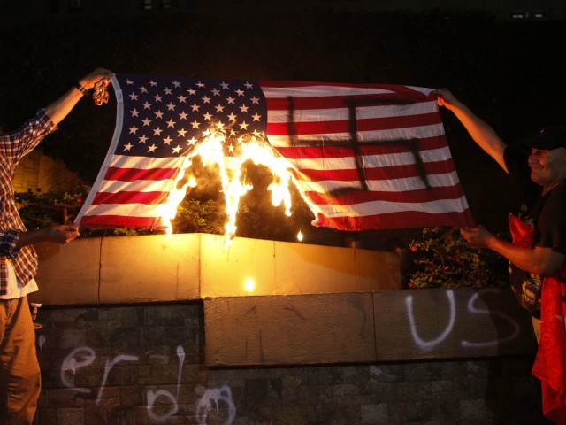 PHOTO: Protesters in Support of Caravan Paint Swastika on American Flag ...