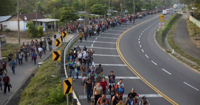 Migrants Break Border Gate, Force Their Way into Mexico - Breitbart