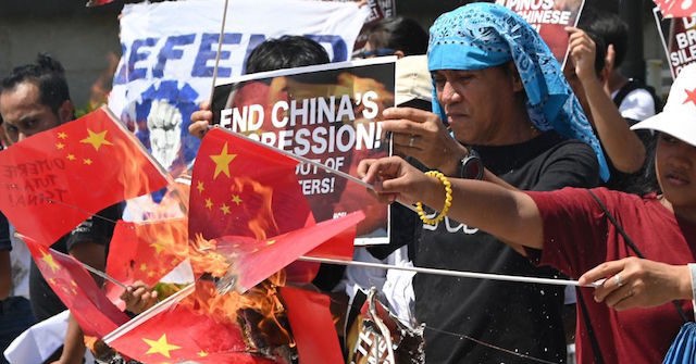 Protesters Burn Chinese Flags Following South China Sea Ship Sinking