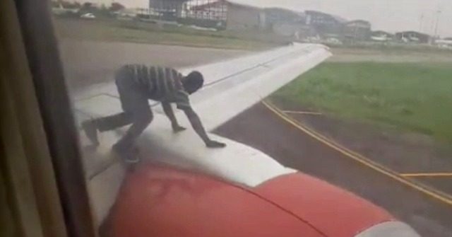 WATCH: Man Leaps onto Plane's Wing as It Tries to Take Off