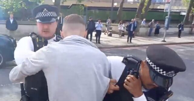 Watch: Police Detain Man Trying to Clear Road of Eco Protesters