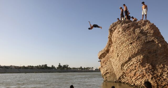 Iraqis beat summer heat by swimming in shrinking Tigris river - Breitbart