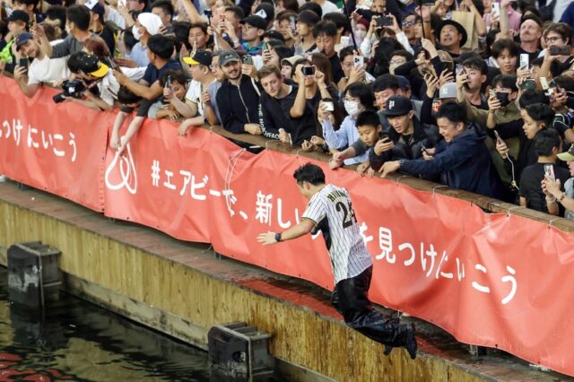 Japan baseball fans leap into river as 'Curse of the Colonel' lifted ...