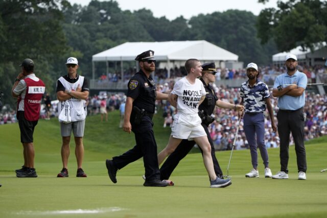 Six climate protesters run onto 18th green and spray powder, delaying ...