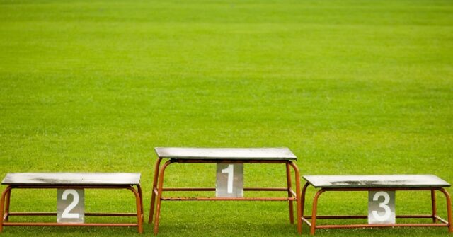 Female Track Star Poses on First-Place Podium After Finishing Second to ...